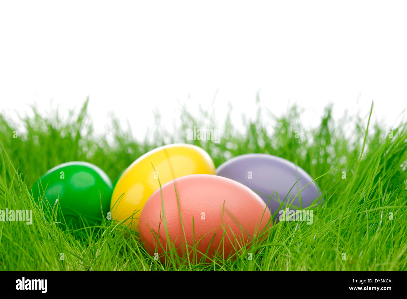 Decorated easter eggs in the grass on blue sky background Stock Photo ...