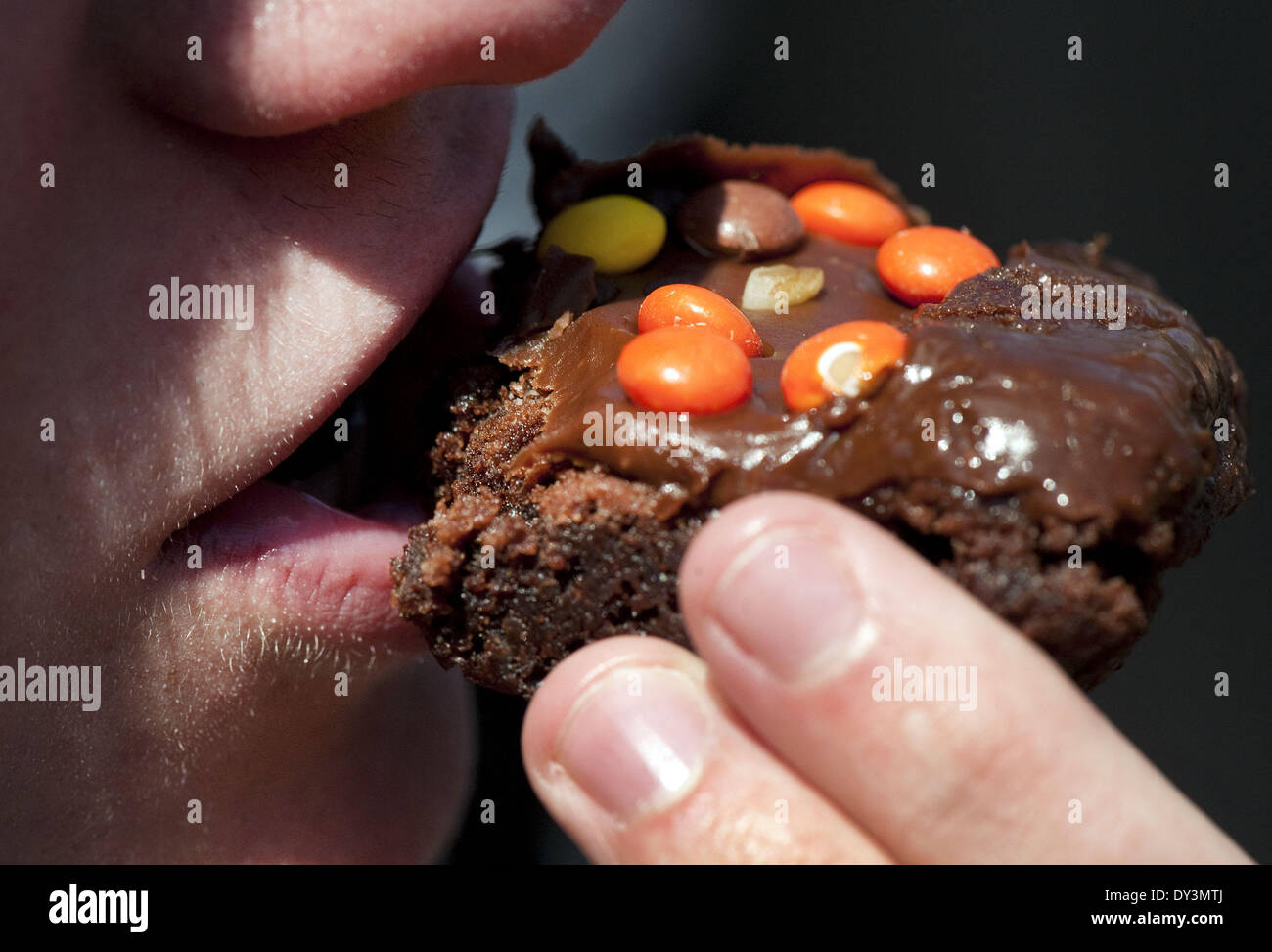 Ann Arbor, MI, USA. 5th Apr, 2014. A man eats a pot brownie on the Diag ...