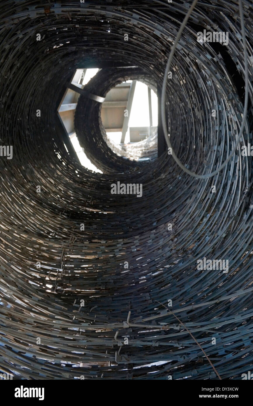 Razor wire is wound in a police machine at Freedom Park in Phnom Penh ...