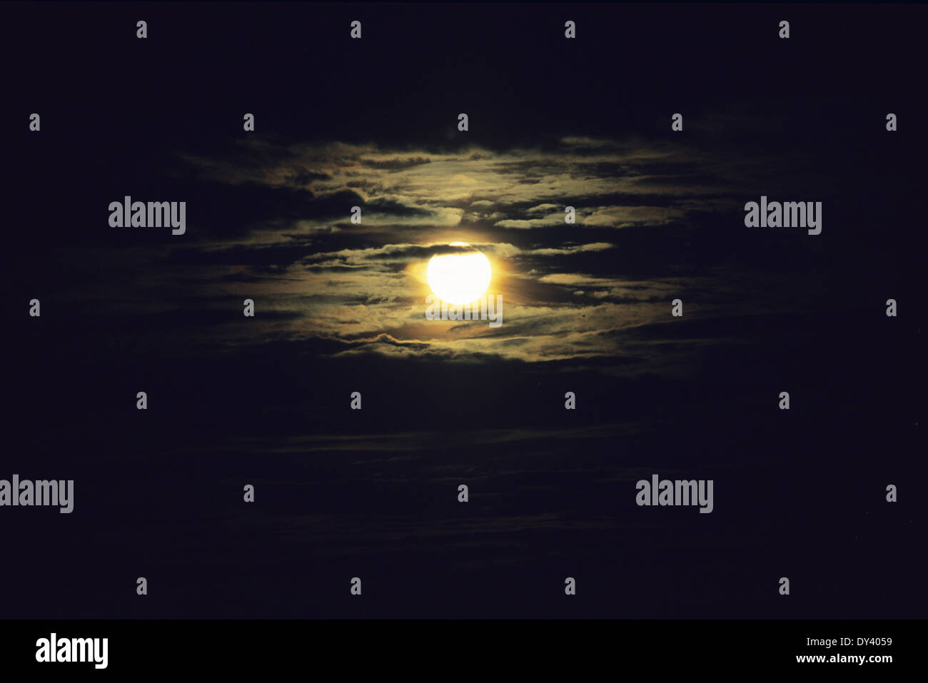 The moon seen through the clouds and haze caused by forest fires ...