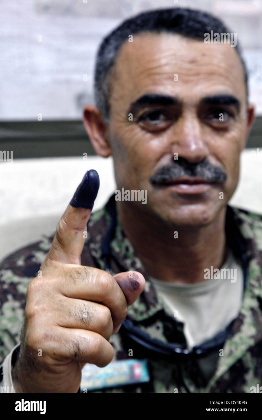 Afghan National Army soldiers hold up their fingers marked with blue ...