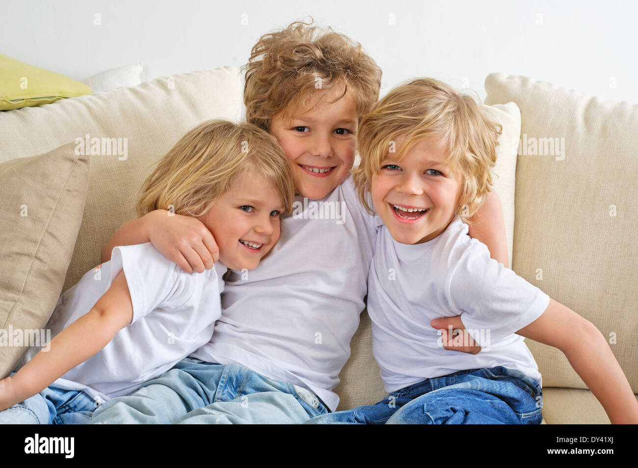 Three brothers hugging and playing on the sofa Stock Photo - Alamy