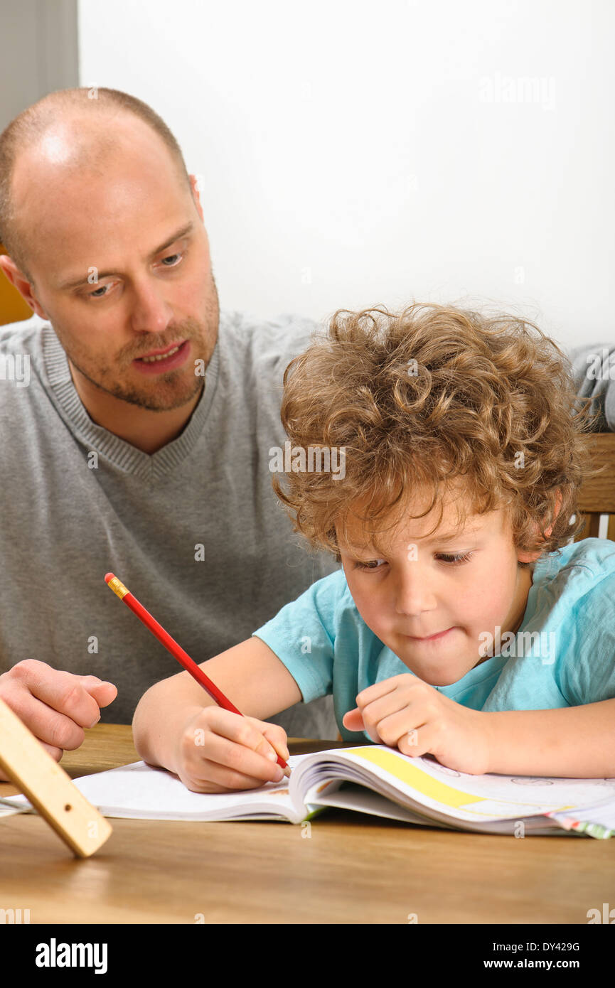 father helping his son with his homework Stock Photo - Alamy