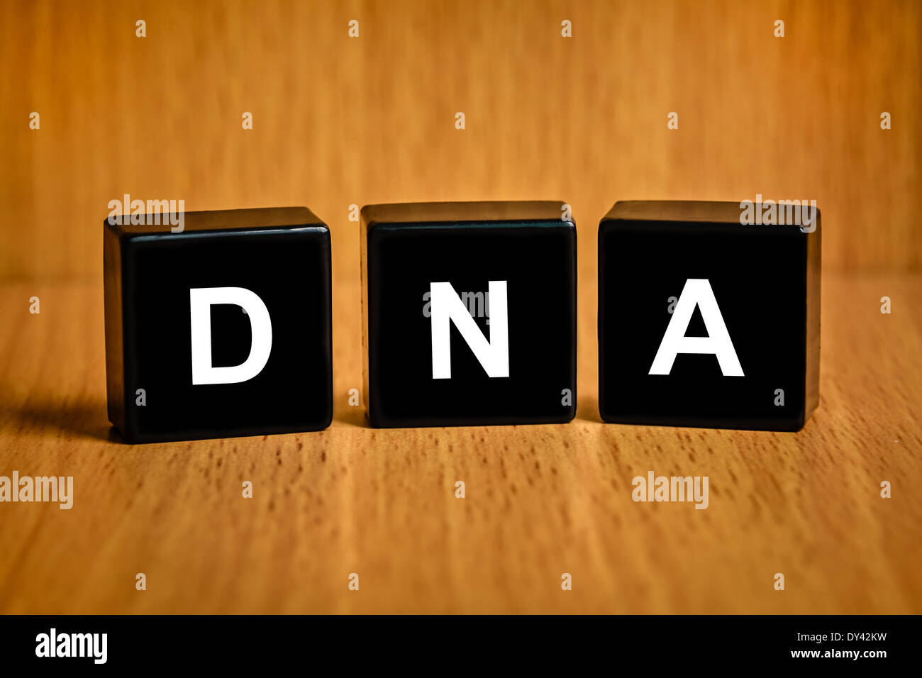 Deoxyribonucleic acid or DNA text on black block Stock Photo - Alamy
