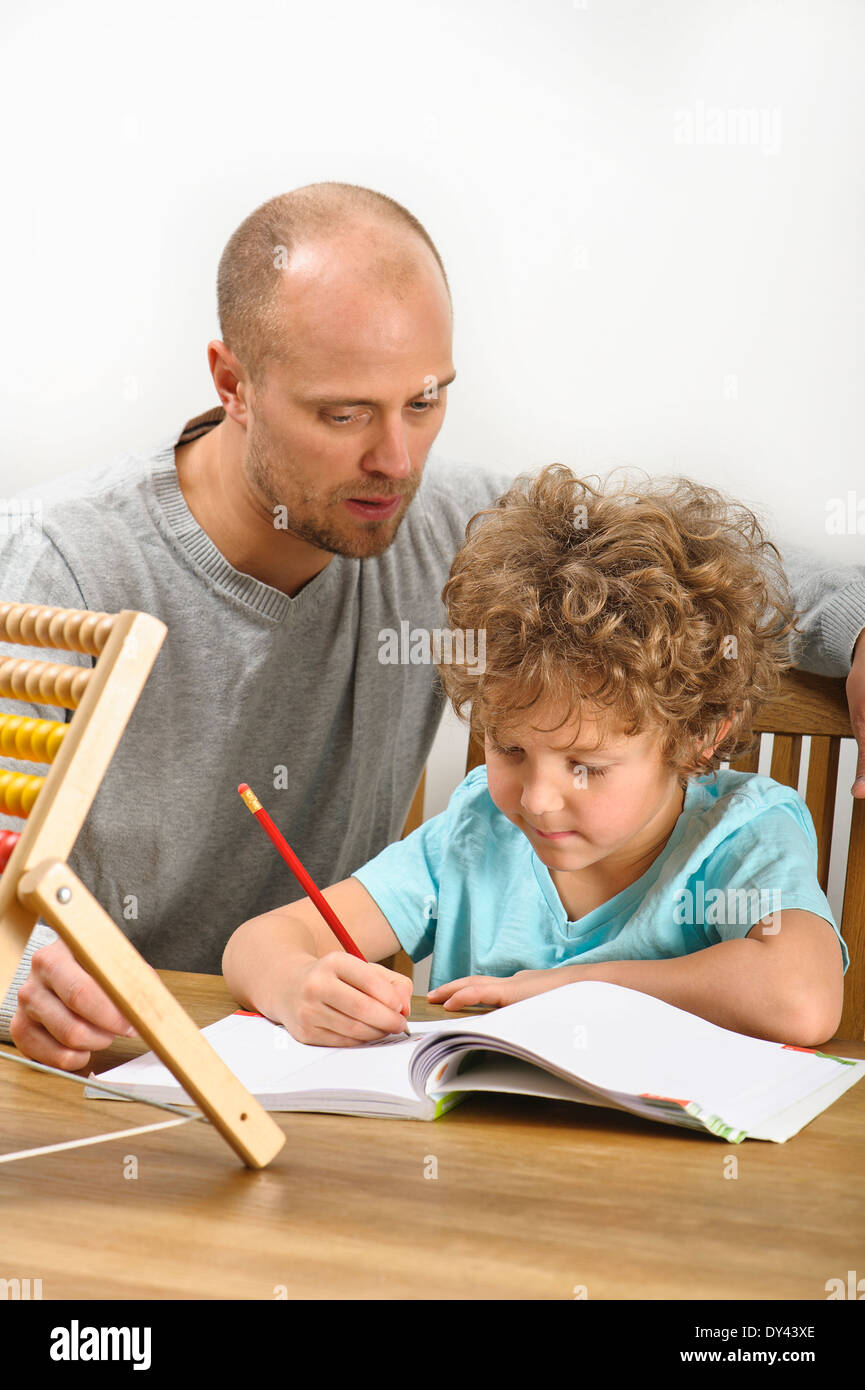Helping his son to do homework hi-res stock photography and images - Alamy
