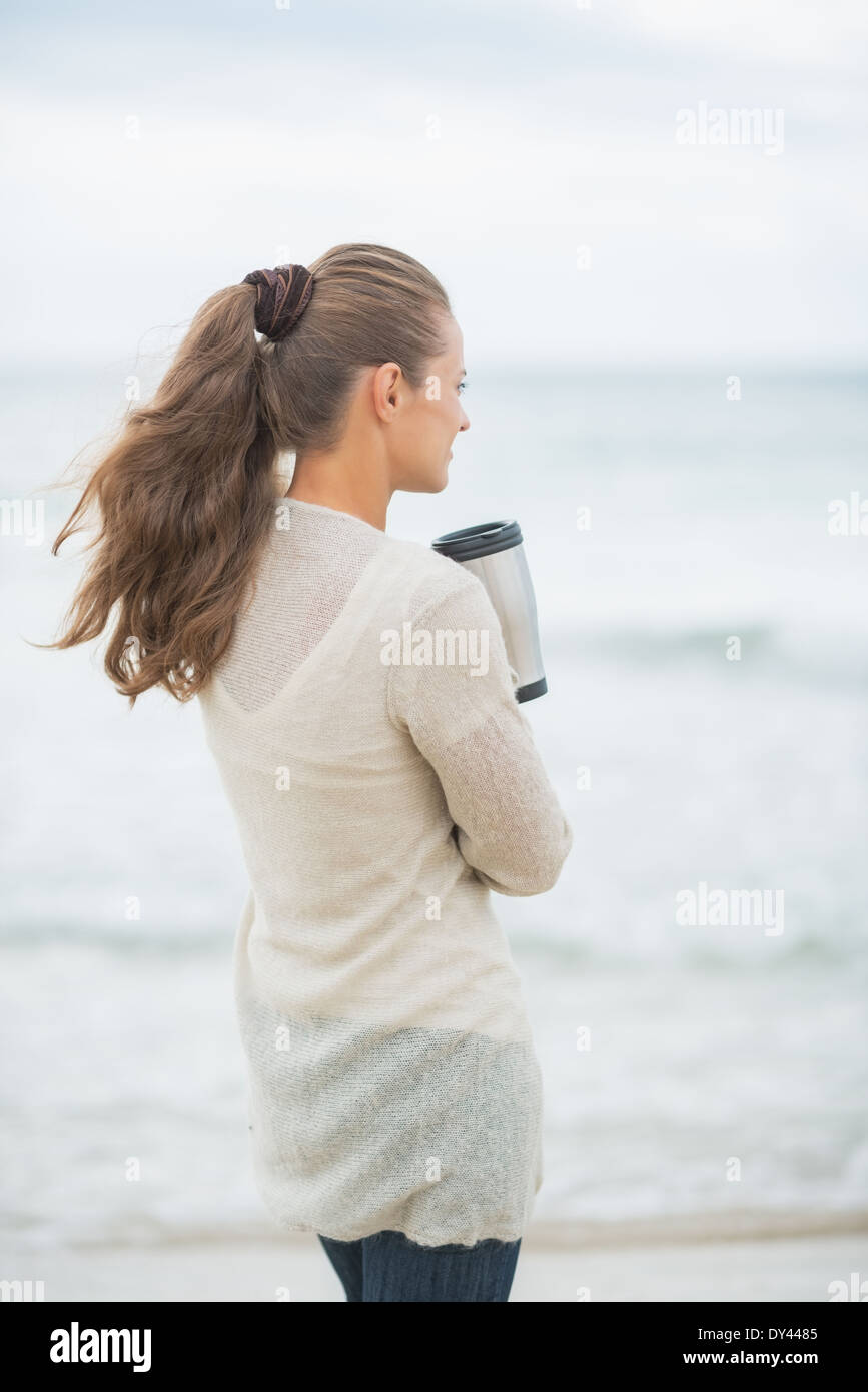 Woman standing beach cold hi-res stock photography and images - Alamy