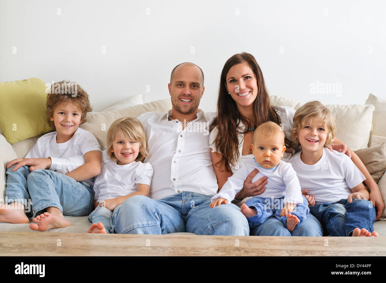 Four brothers and their parents sitting on a sofa Stock Photo - Alamy