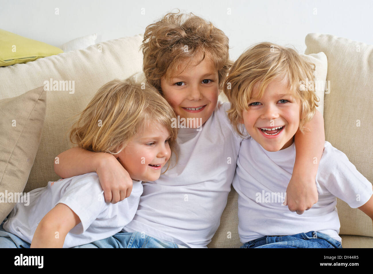 Three brothers hugging and playing on the sofa Stock Photo - Alamy