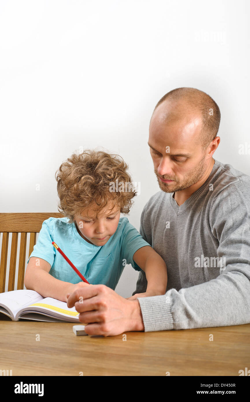 Helping his son to do homework hi-res stock photography and images - Alamy