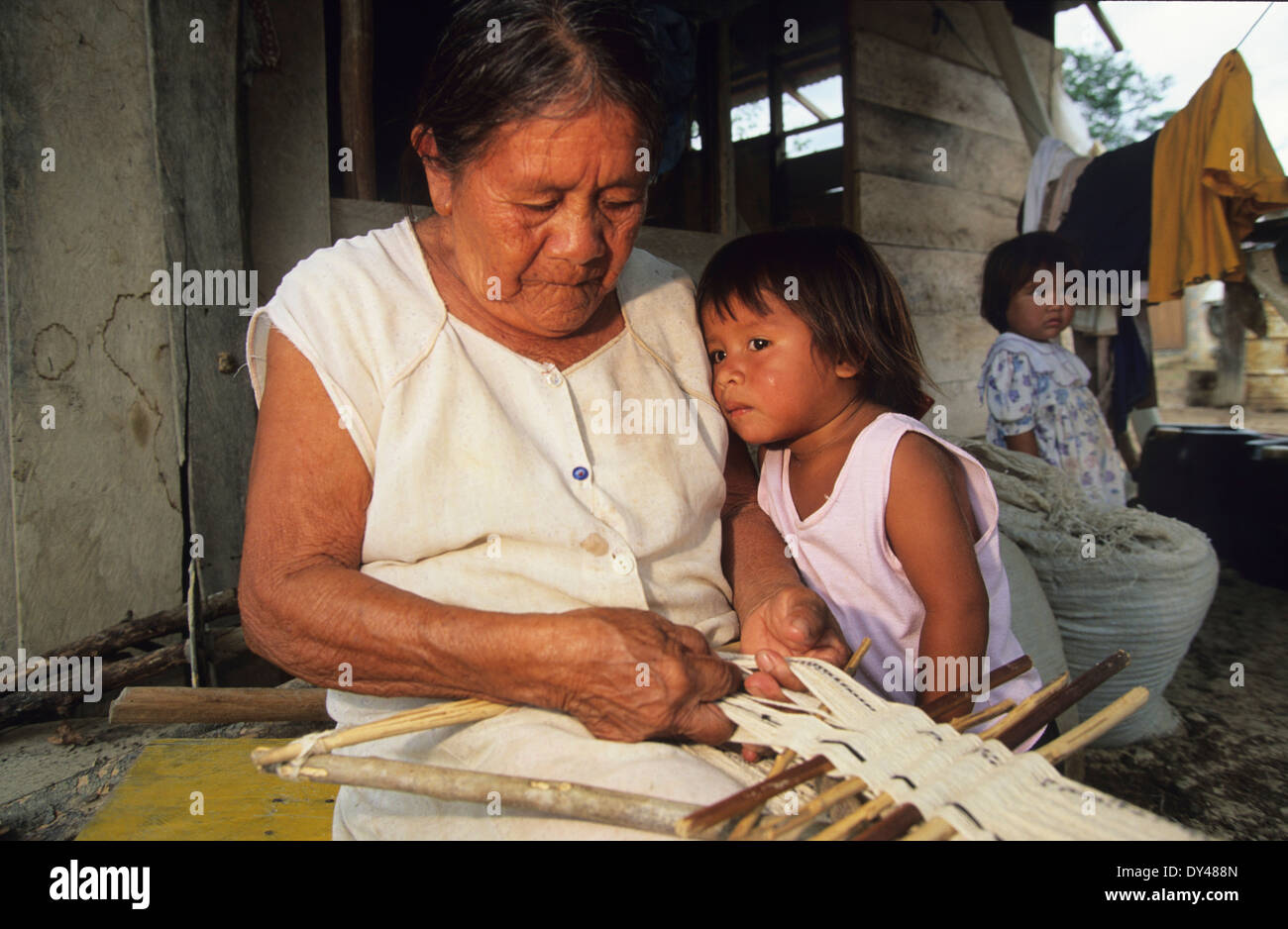 Macuxi indians , grandmother weaving with family. Roraima Province ...