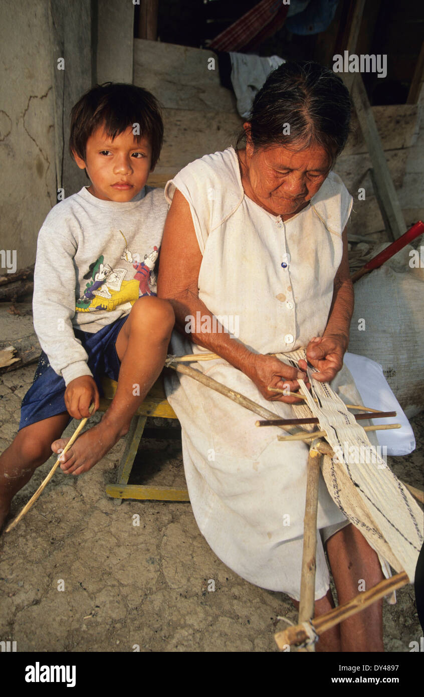 Macuxi indians , grandmother weaving with family. Roraima Province ...