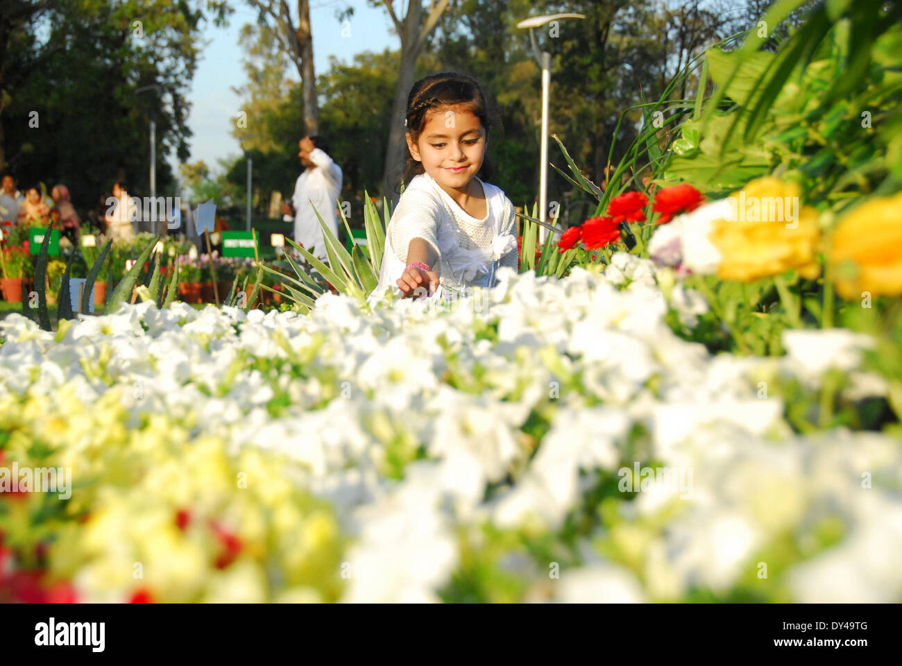 Islamabad, Pakistan. 6th Apr, 2014. A girl enjoys flowers on the last ...