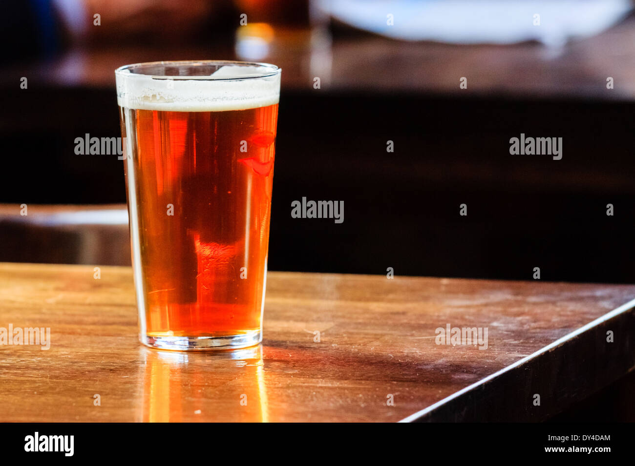 An english ale on a wooden table in a pub in London, UK Stock Photo - Alamy