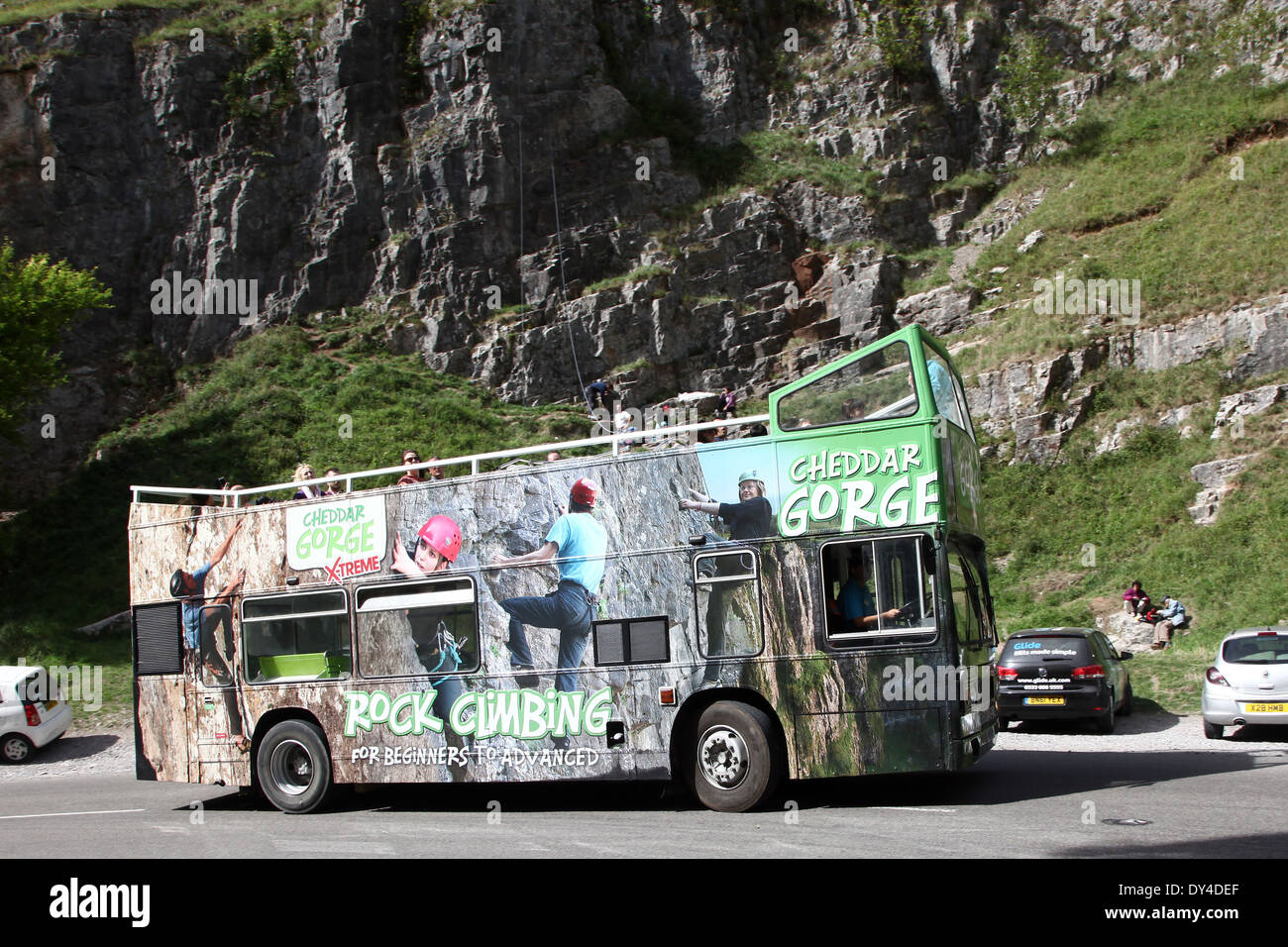 Cheddar Gorge tourist open top bus driving the gorge with passengers ...