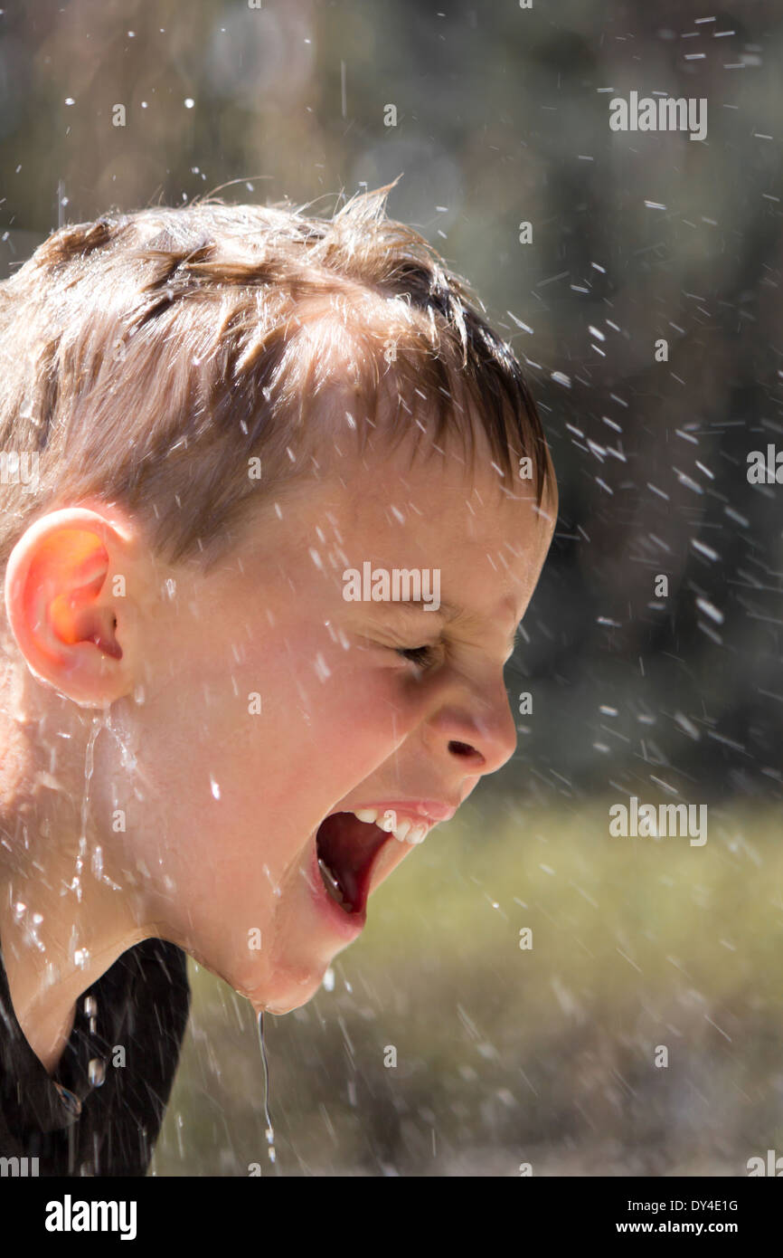Soaking wet young boy laughing hi-res stock photography and images - Alamy