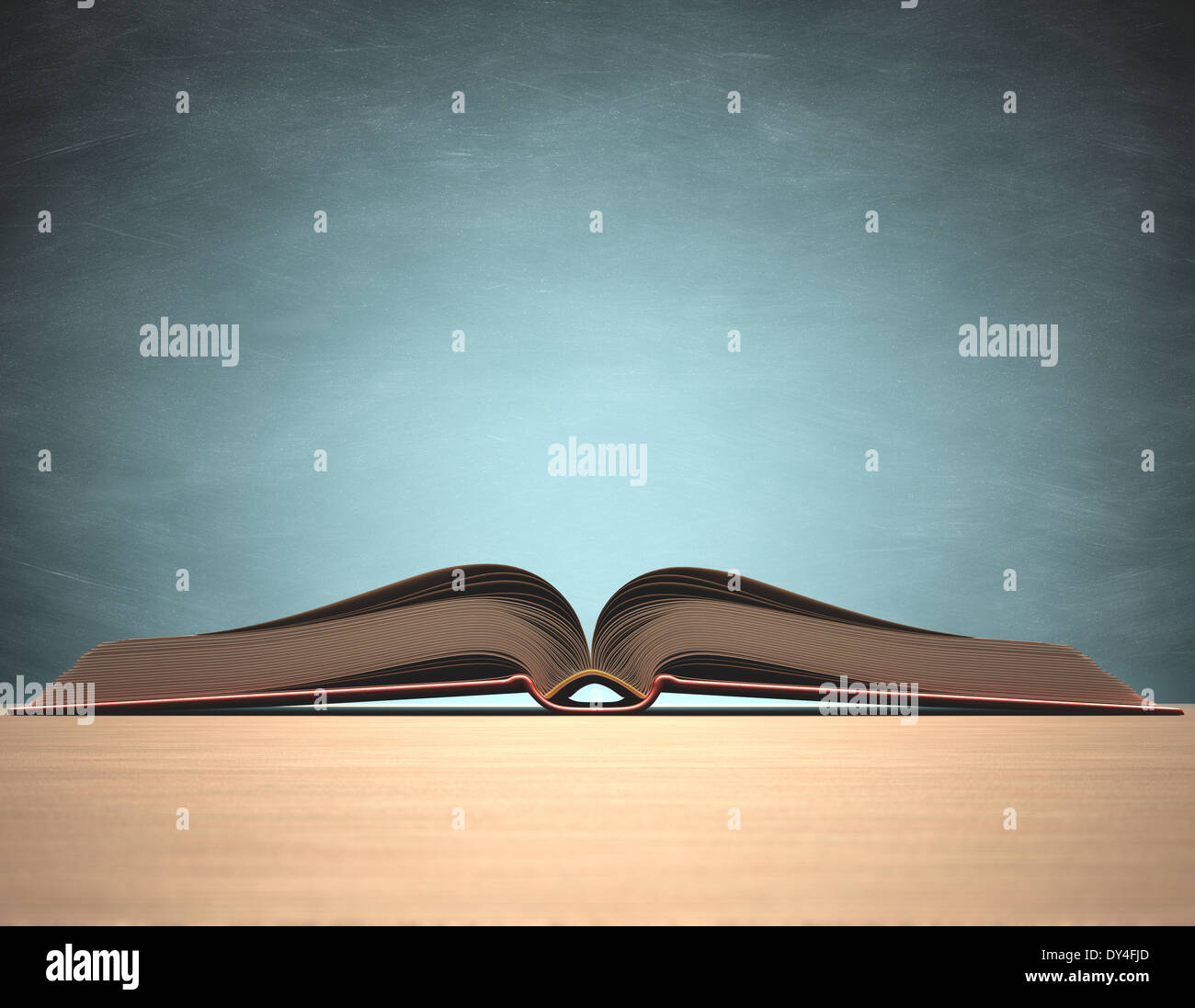 Open book over the table with blackboard on background. Clipping path ...
