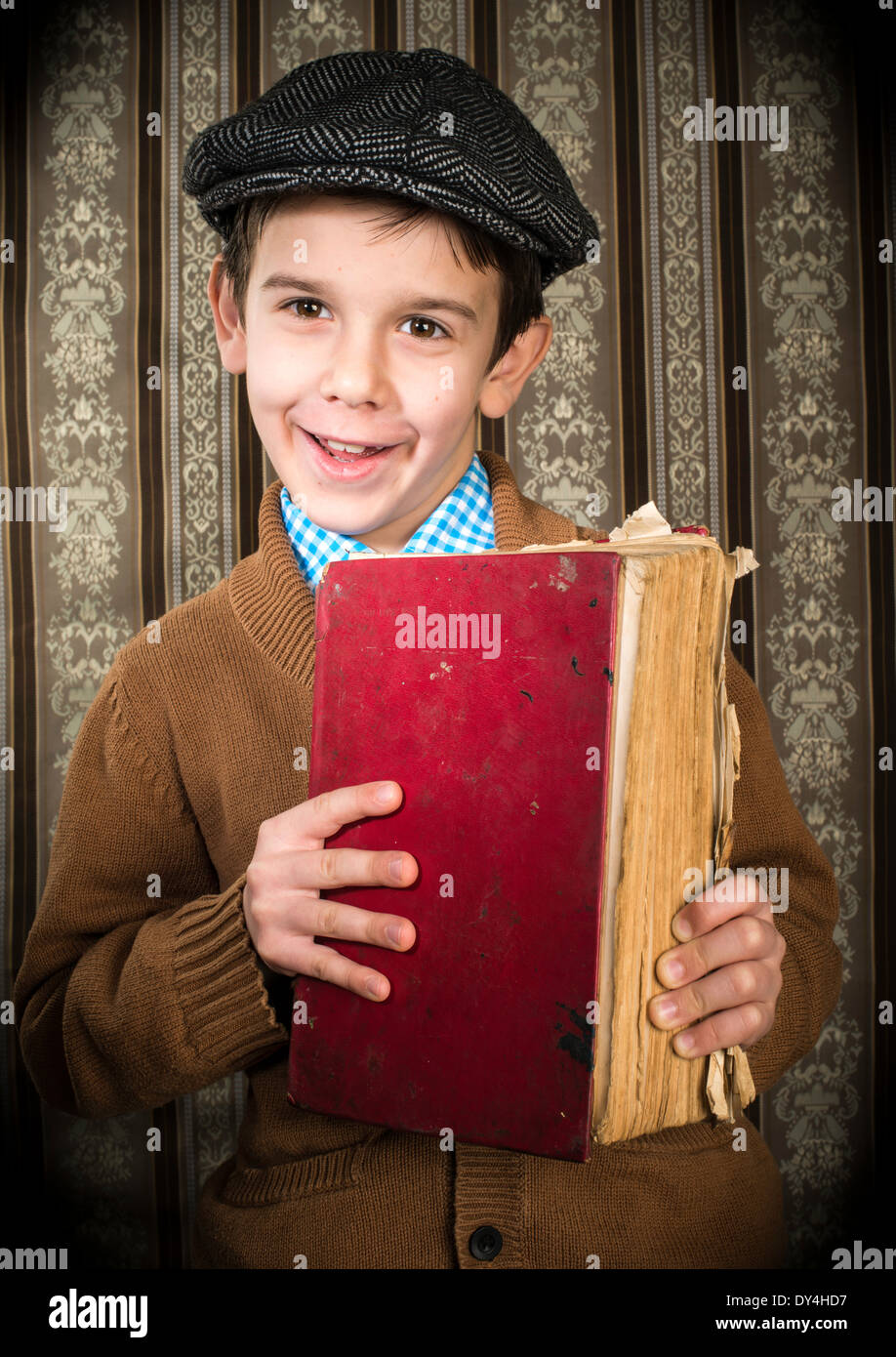 Child with red vintage book. Vintage clothes and hat Stock Photo - Alamy