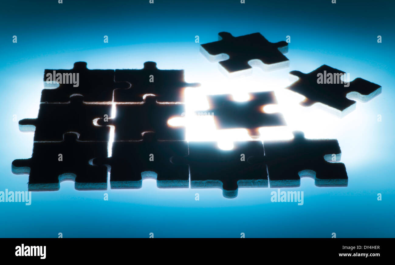 Wooden puzzle and backlight background. Close up. Blue color light ...