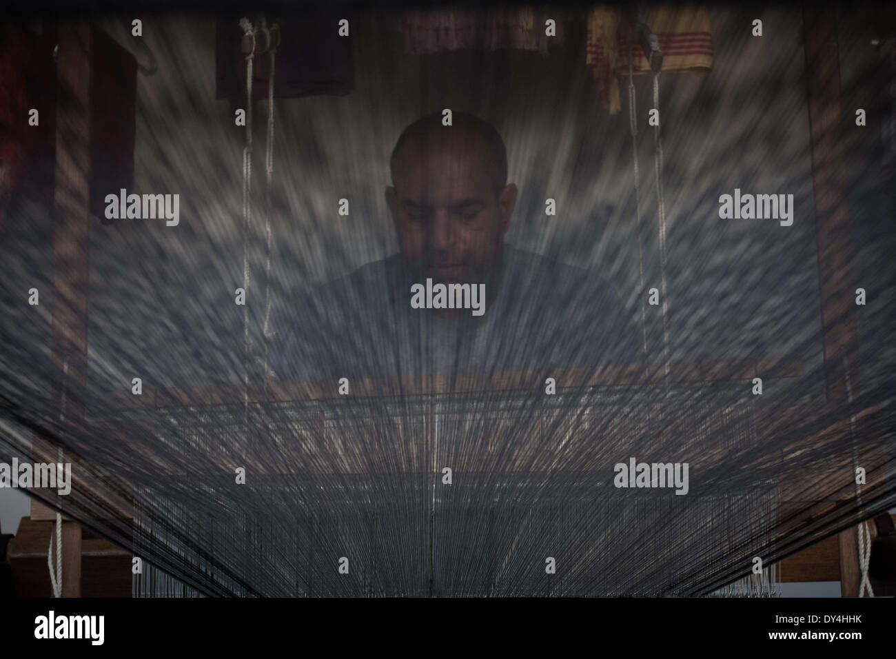 Manama, Bangladesh. 6th April, 2014. Bahraini man spin cloth as he ...