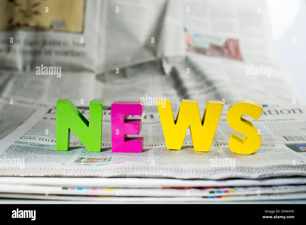 Word news on newspaper. Wooden letters Stock Photo - Alamy