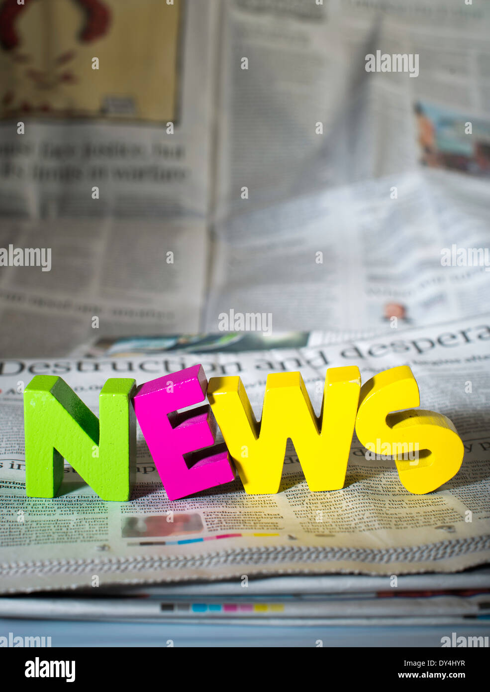 Word news on newspaper. Wooden letters Stock Photo - Alamy