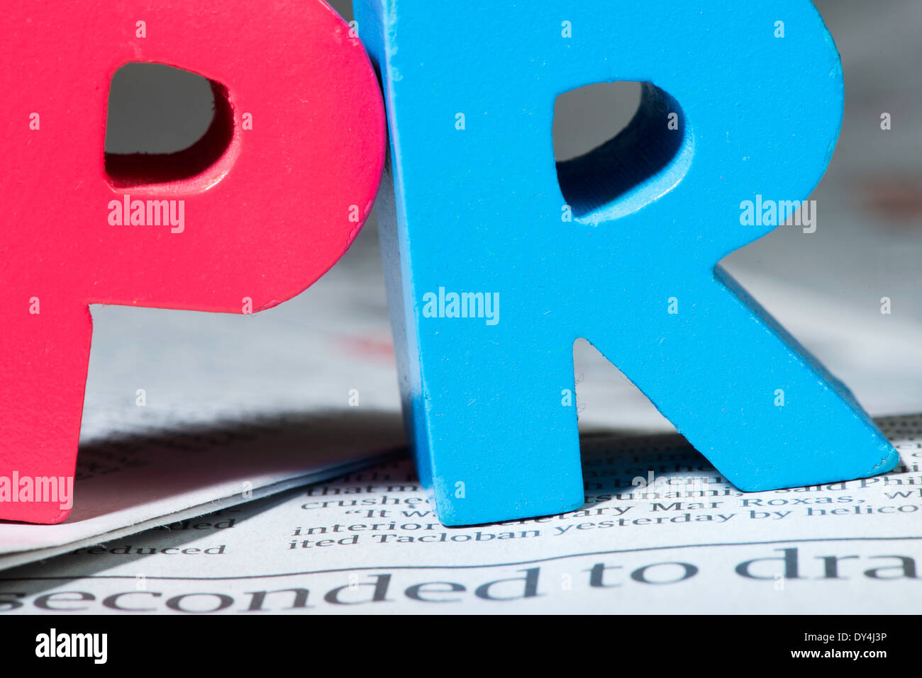 Word PR on newspaper. Wooden letters Stock Photo - Alamy