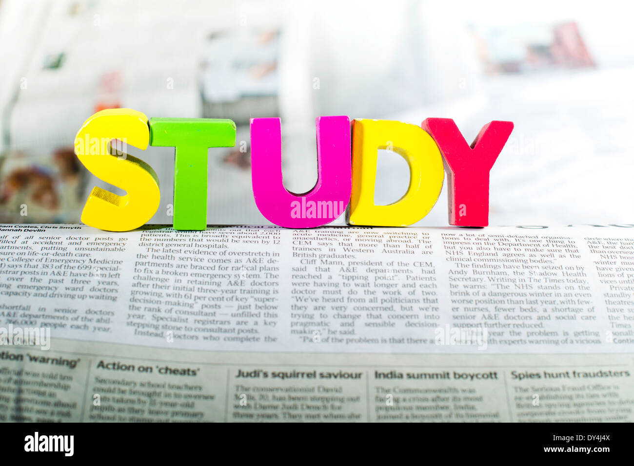 Word study on newspaper page. Wooden letters Stock Photo - Alamy