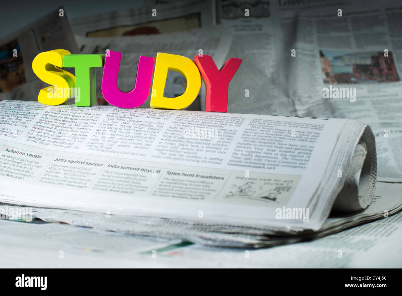 Word study on newspaper page. Wooden letters Stock Photo - Alamy