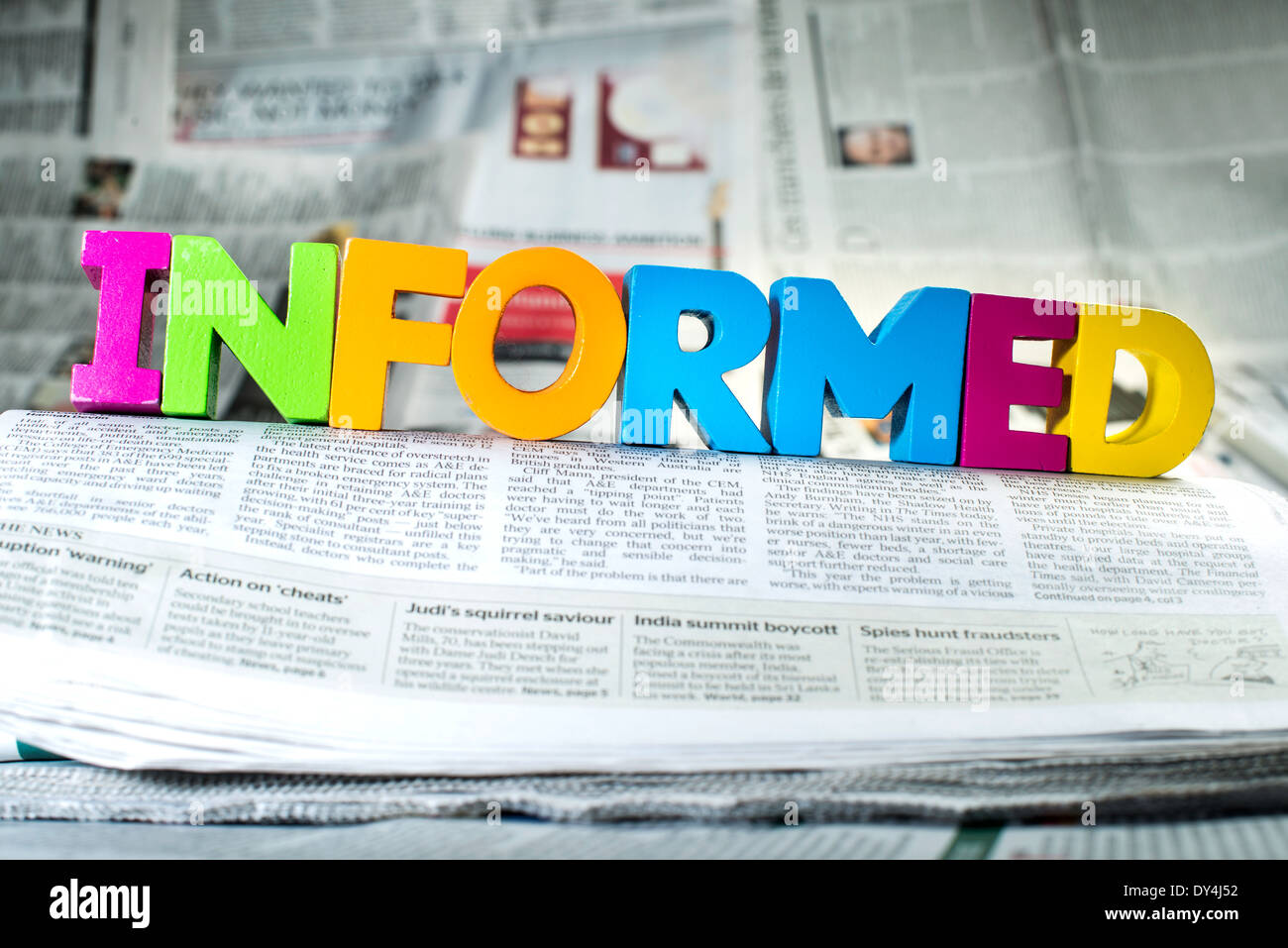 Word informed on newspaper. Wooden letters Stock Photo - Alamy
