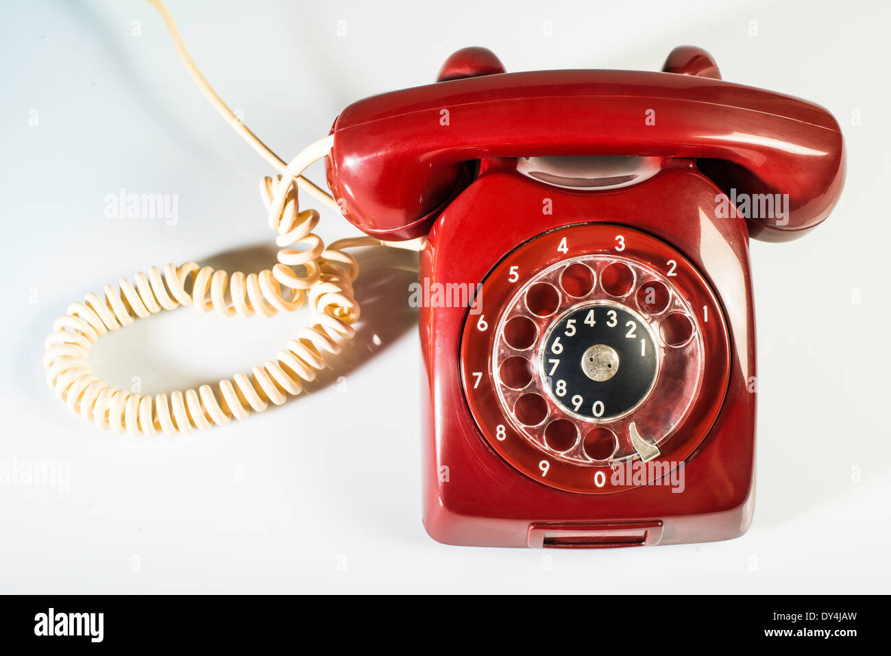 Vintage red phone on white background. White cable Stock Photo - Alamy