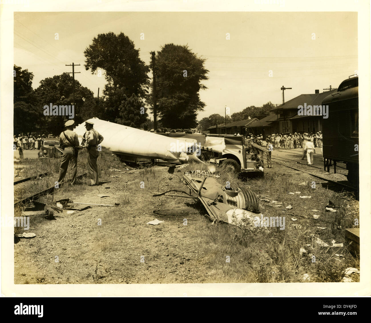 A tragic photograph documenting the aftermath of a train and bus ...