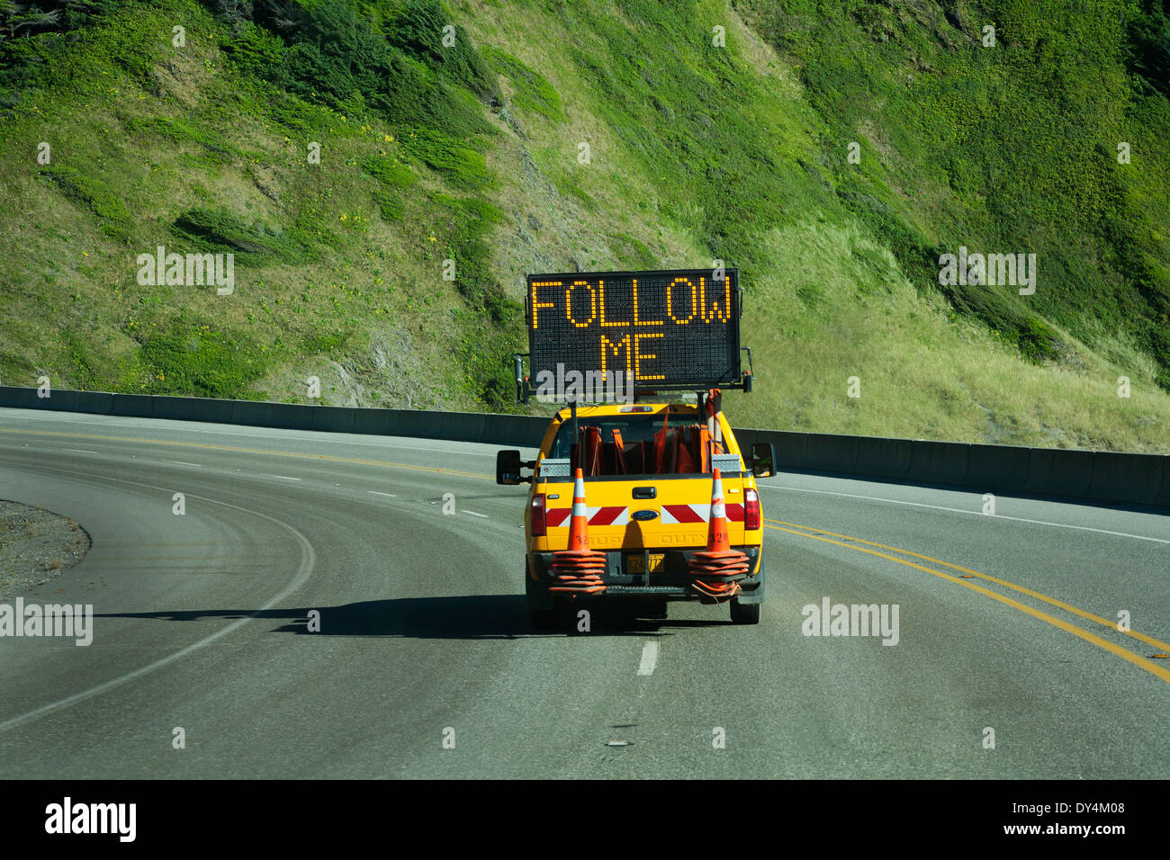 road construction ahead you must follow the pilot truck on a road ...