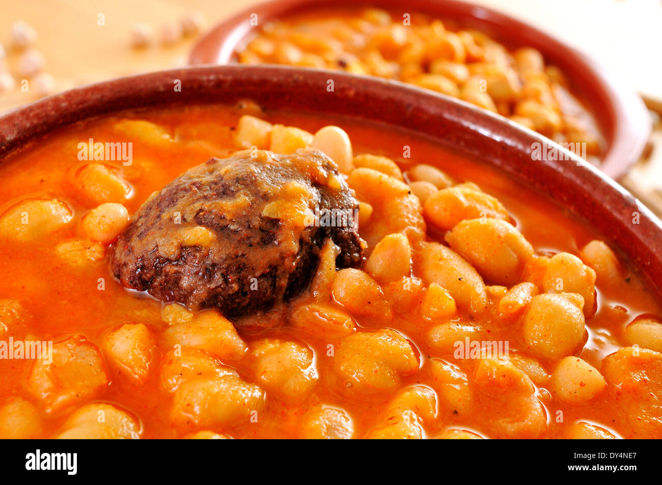 some earthenware bowls with potaje de judias y garbanzos, a traditional ...