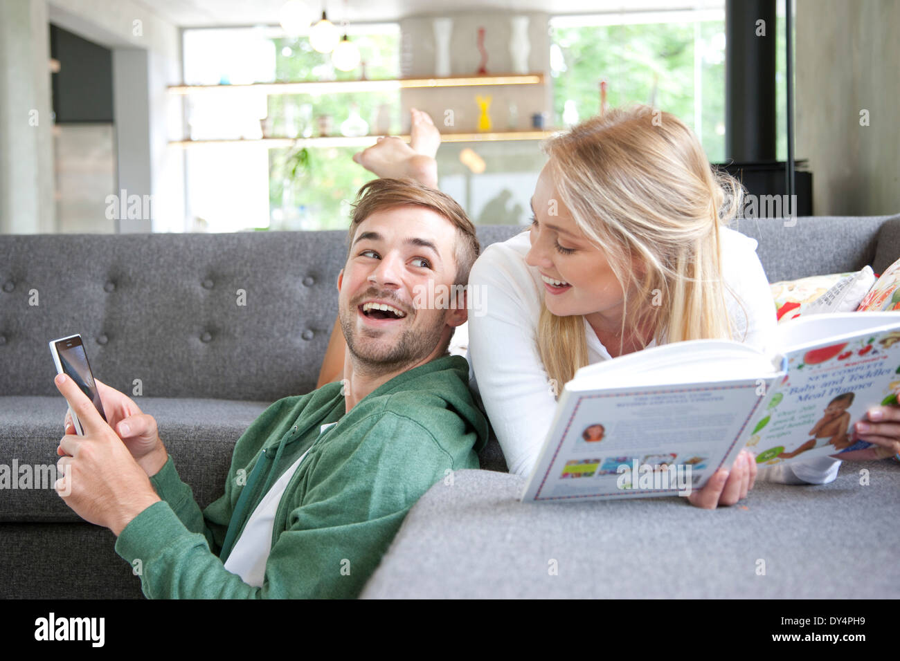 Family sofa lounge reading book hi-res stock photography and images - Alamy