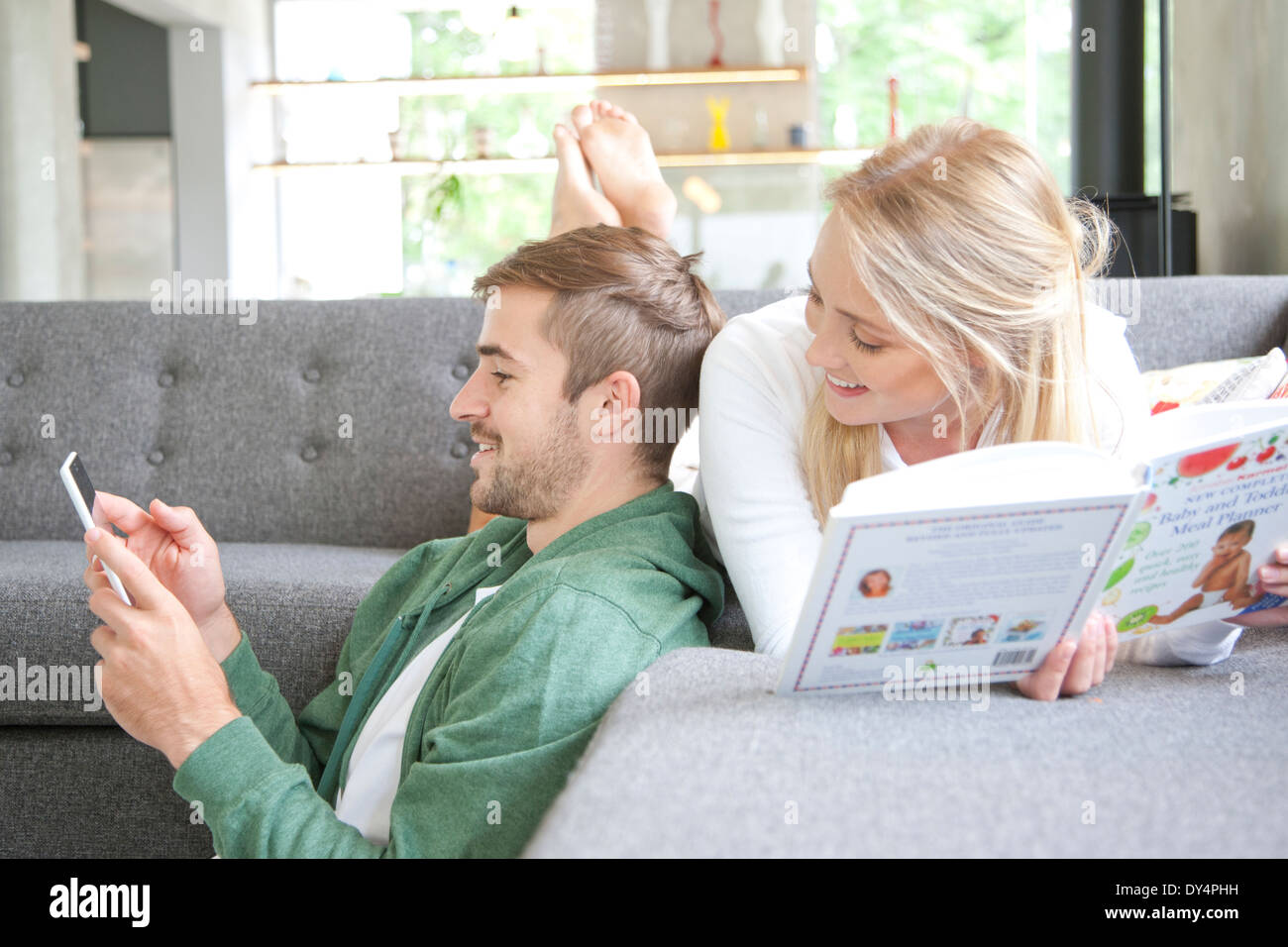 Family sofa lounge reading book hi-res stock photography and images - Alamy