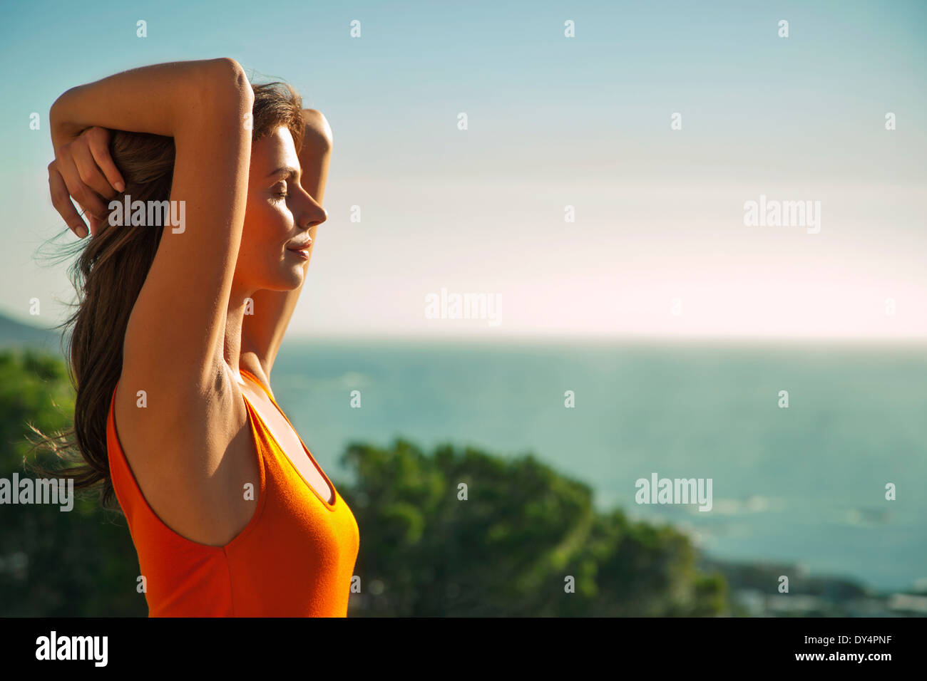 Woman arms behind head hi-res stock photography and images - Alamy