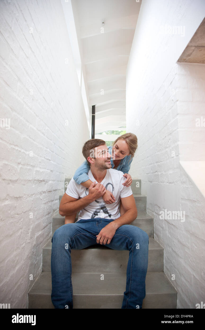 Young couple sitting on stairs hi-res stock photography and images - Alamy