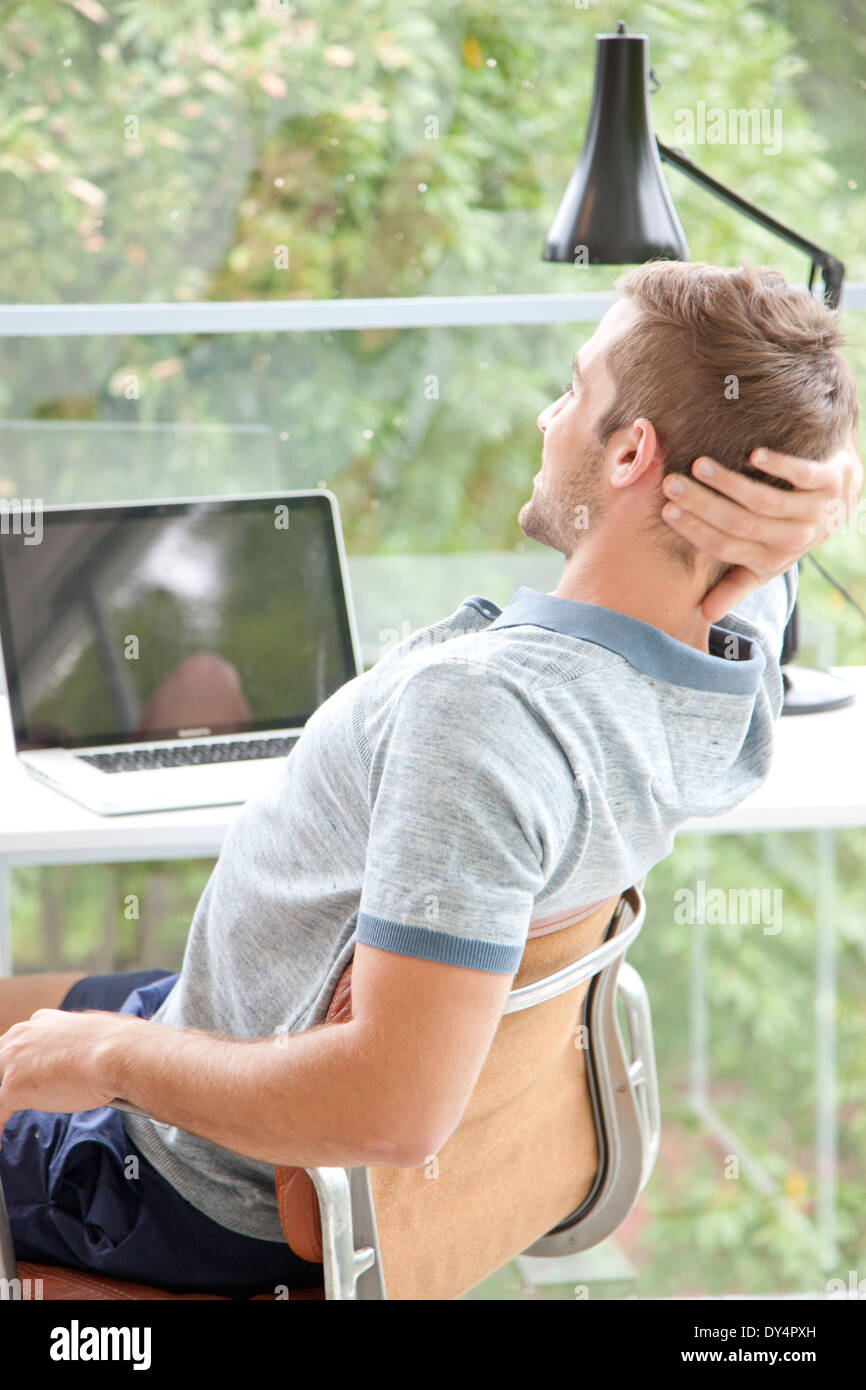 Man desk leaning back hands hi-res stock photography and images - Alamy