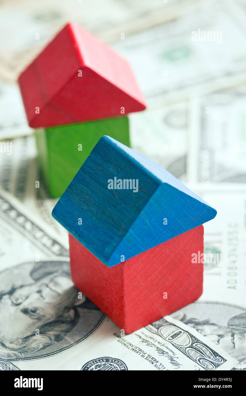 the house made from wooden toy blocks on dollar background Stock Photo ...