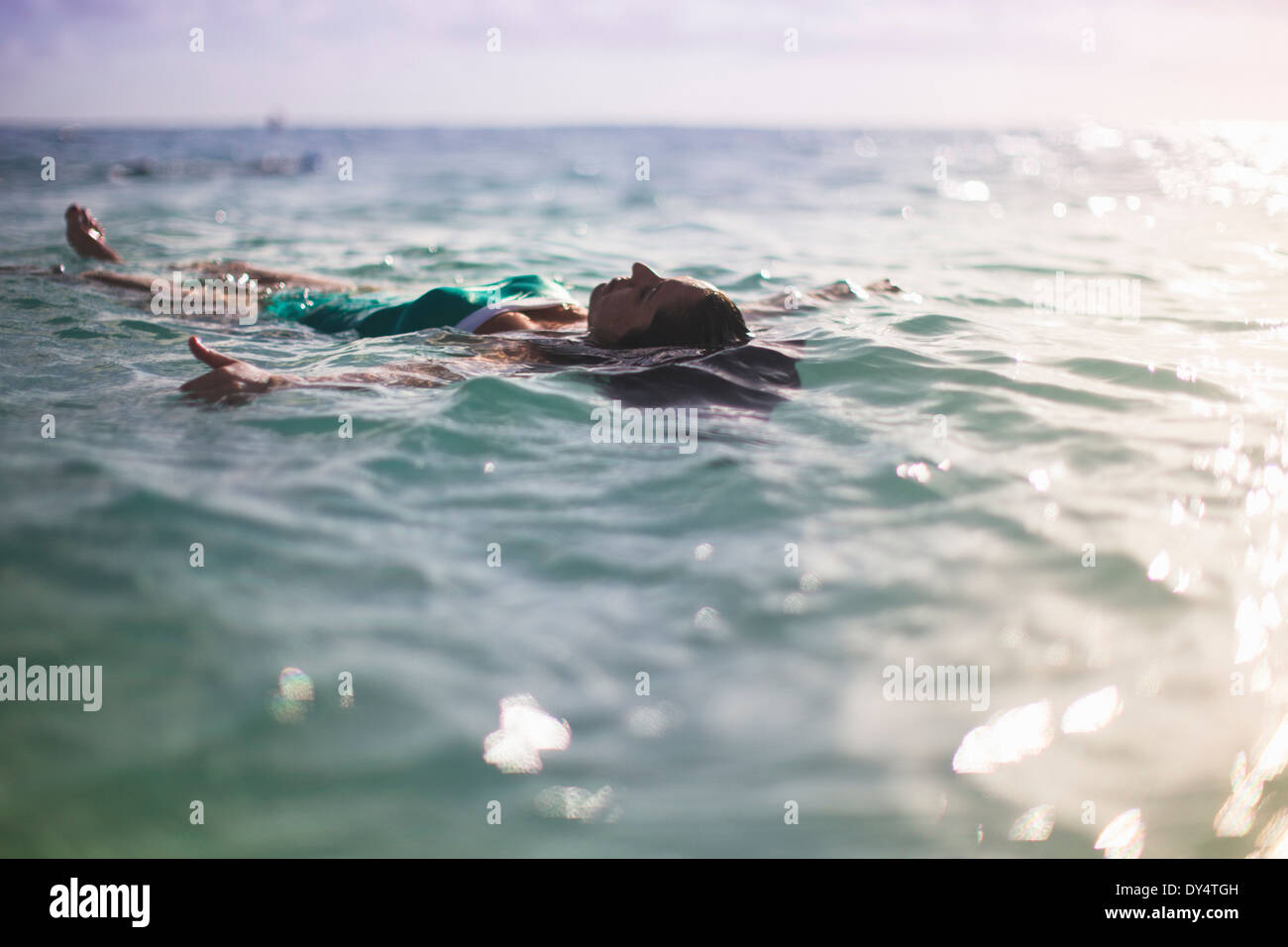 Woman float sea hi-res stock photography and images - Alamy