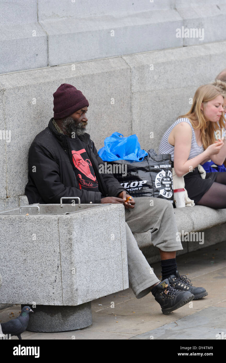 A bearded black homeless person sitting In Trafalgar Square with his ...