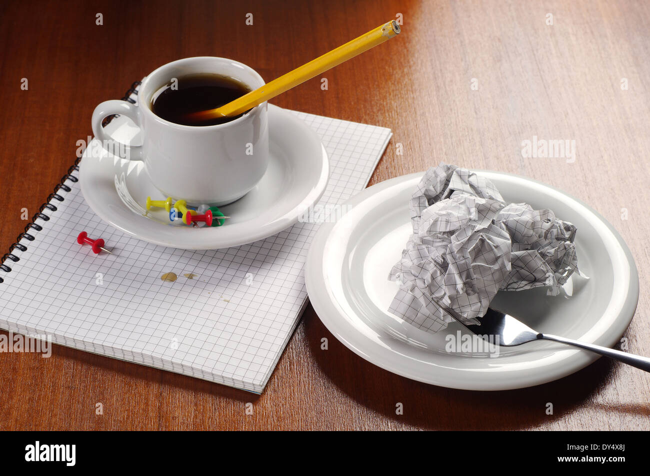 Crumpled paper on a plate, notebook and coffee Stock Photo - Alamy