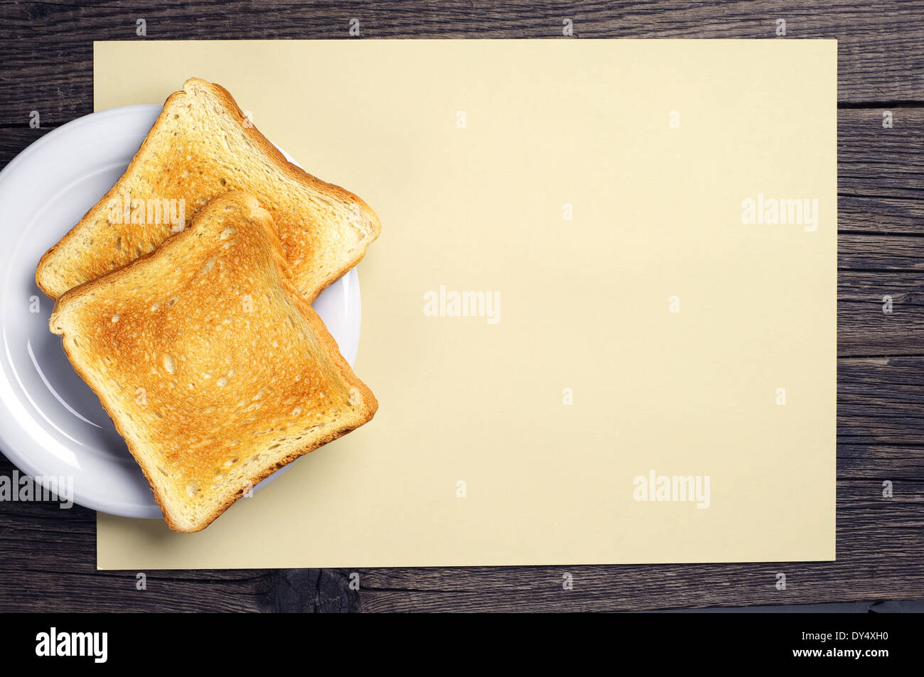 Background with slices of toast bread and blank sheet of yellow paper ...