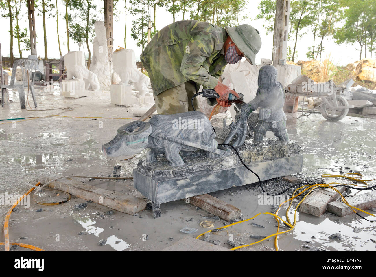 Stone cutter cutting rock with saw to carve into large ornaments for ...