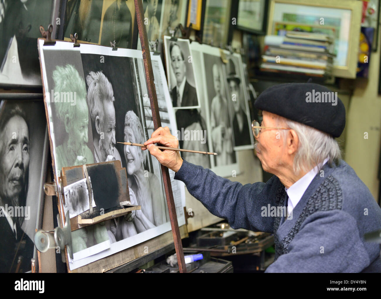 Vietnamese artist smudging graphite with smudging stick to render copy ...