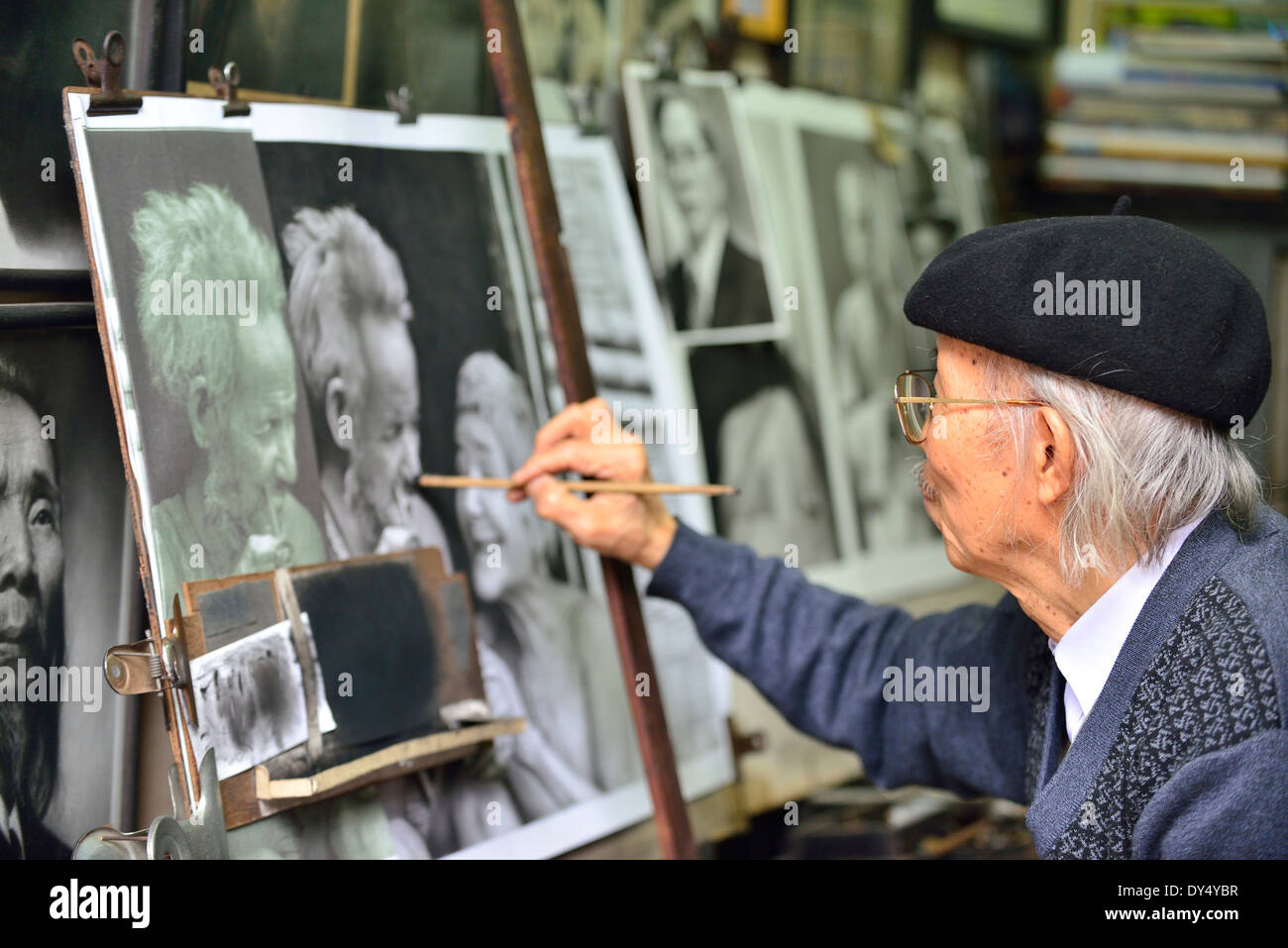 Vietnamese artist smudging graphite with smudging stick to render copy ...