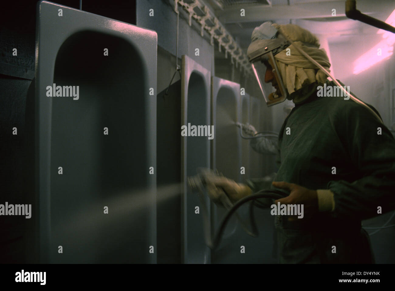 Operator spraying enamel on a steel bath production line Stock Photo ...