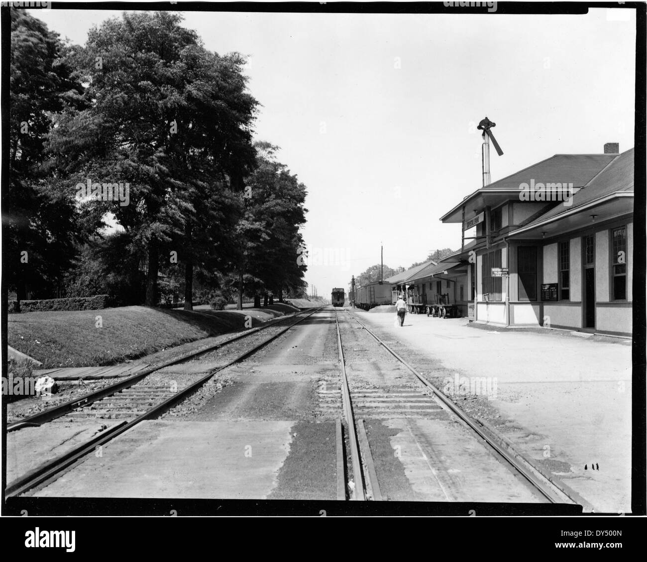 A photograph showing railroad tracks and a depot, highlighting the ...
