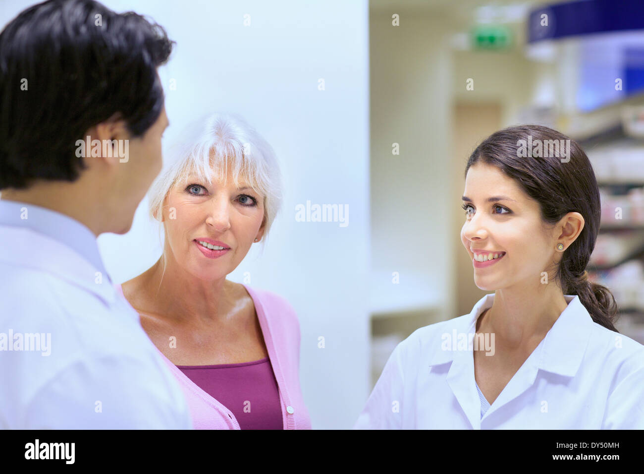 Pharmacists chatting to customer on medication Stock Photo - Alamy