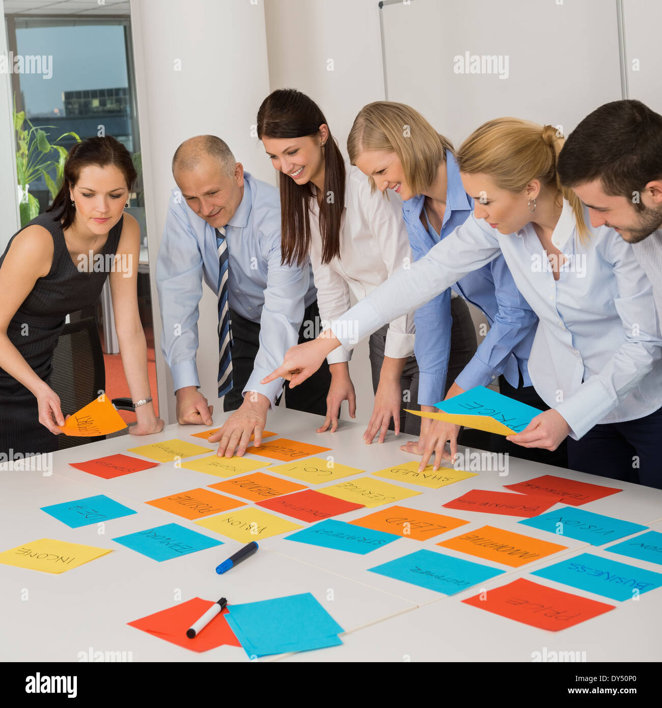 Business team brainstorming using color labels on table in office Stock ...